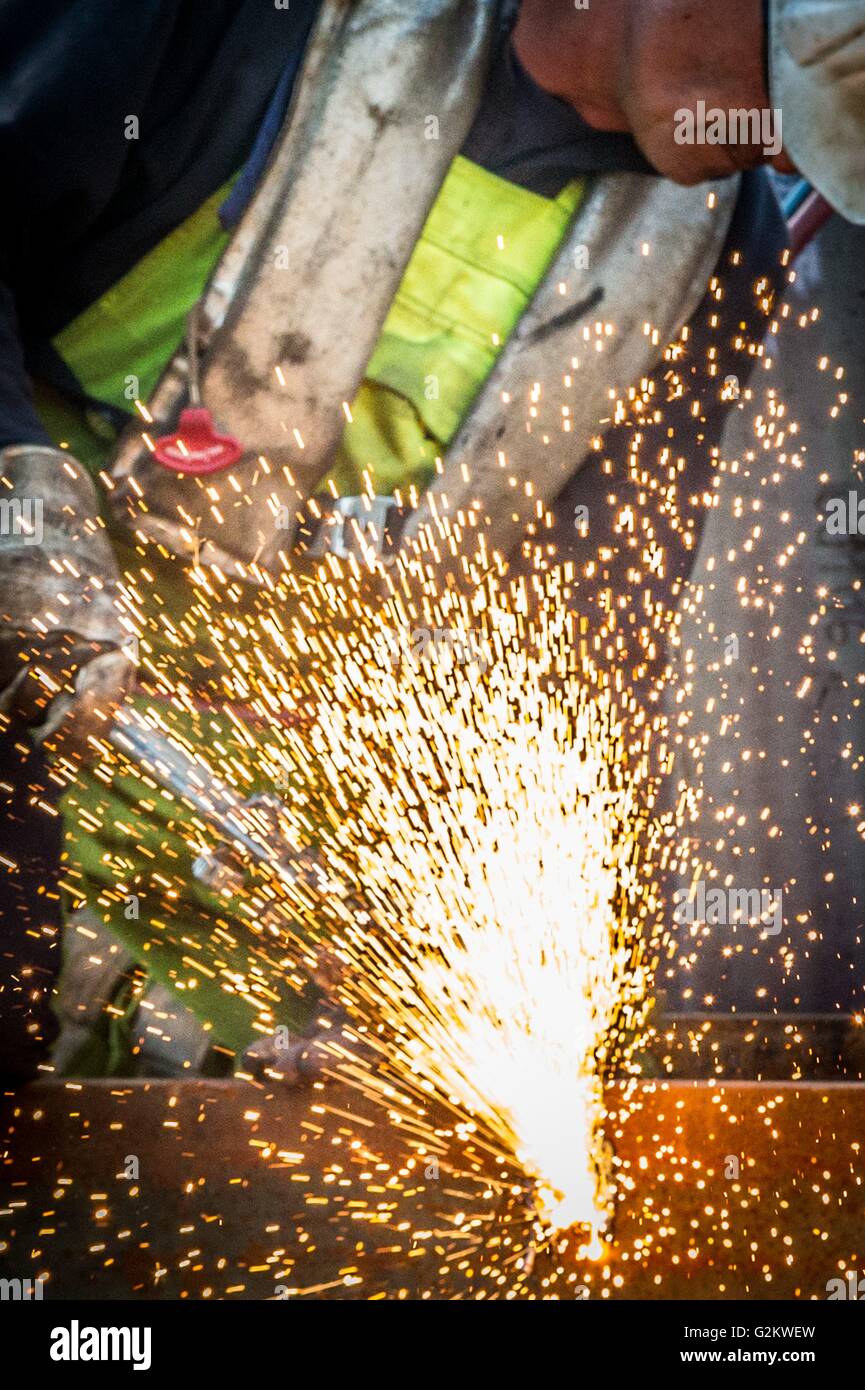 Cutting a steel beam with flying sparks, Neckar river construction site ...