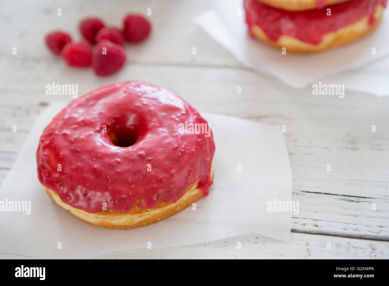 Donut with Raspberry Icing Stock Photo - Alamy