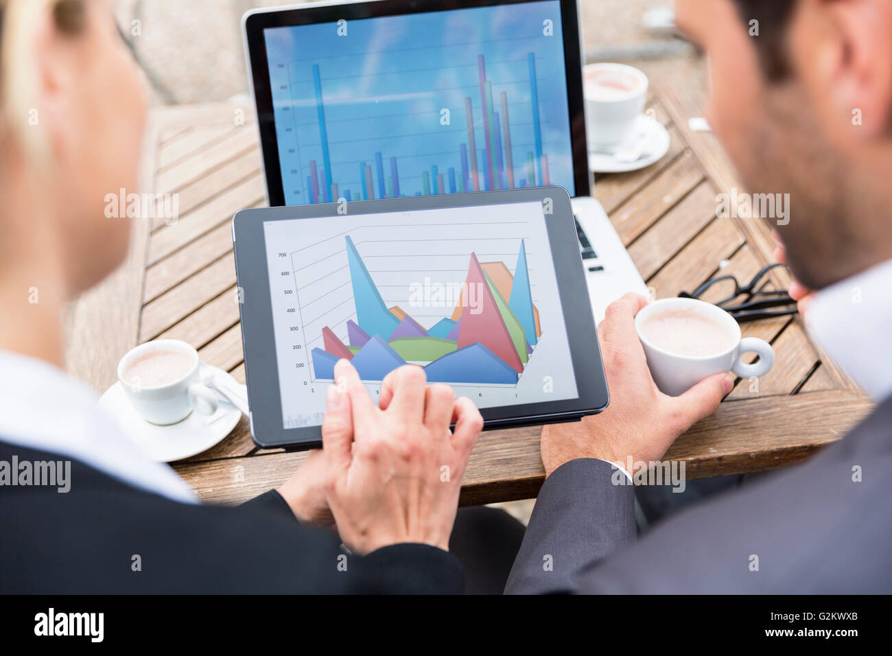 Business people analyzing graph during a coffee break Stock Photo - Alamy