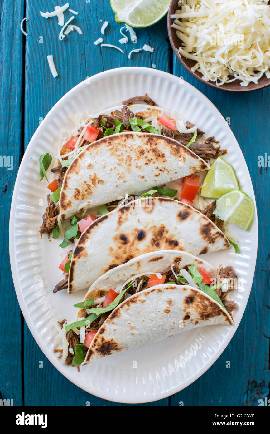 Soft Shell Tacos with Shredded Beef on White Plate, High Angle View ...
