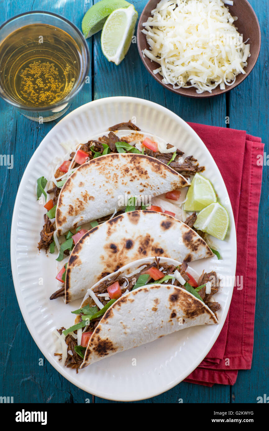 Soft Shell Tacos with Shredded Beef on White Plate, High Angle View ...