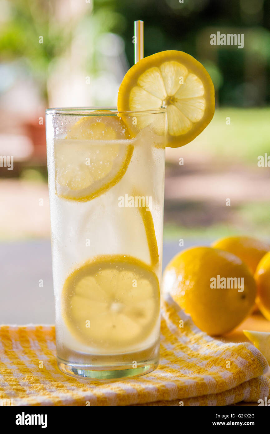 Glass of Lemonade with Lemon Slices and Straw Stock Photo - Alamy