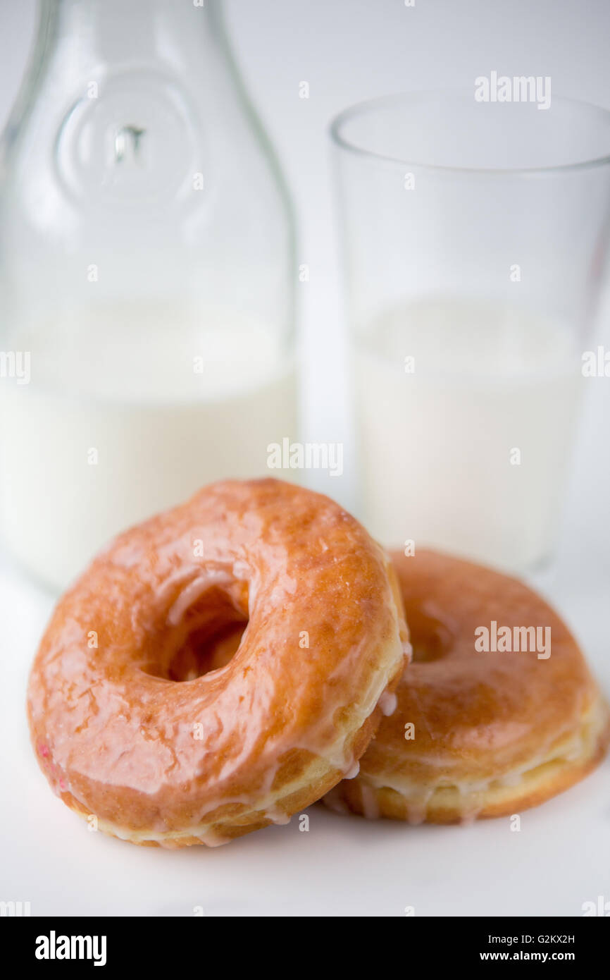 Two Glazed Doughnuts with Milk Stock Photo - Alamy