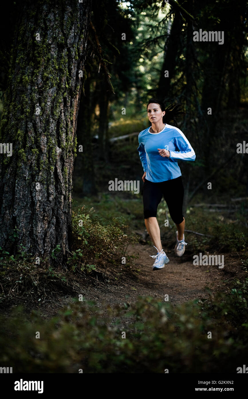 Woman Running on Trail in Woods II Stock Photo - Alamy
