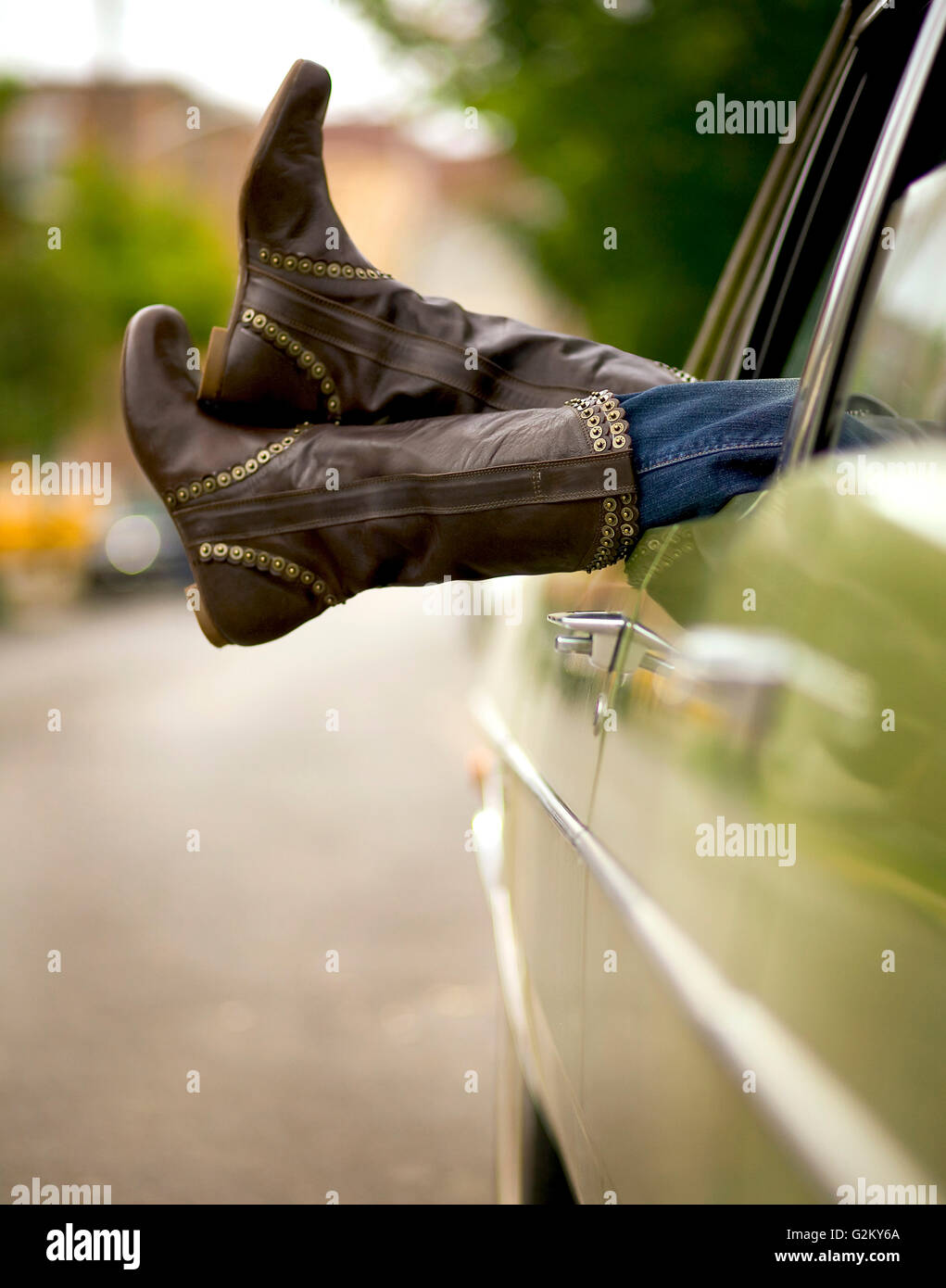 Boots Sticking Out of Car Window Stock Photo - Alamy