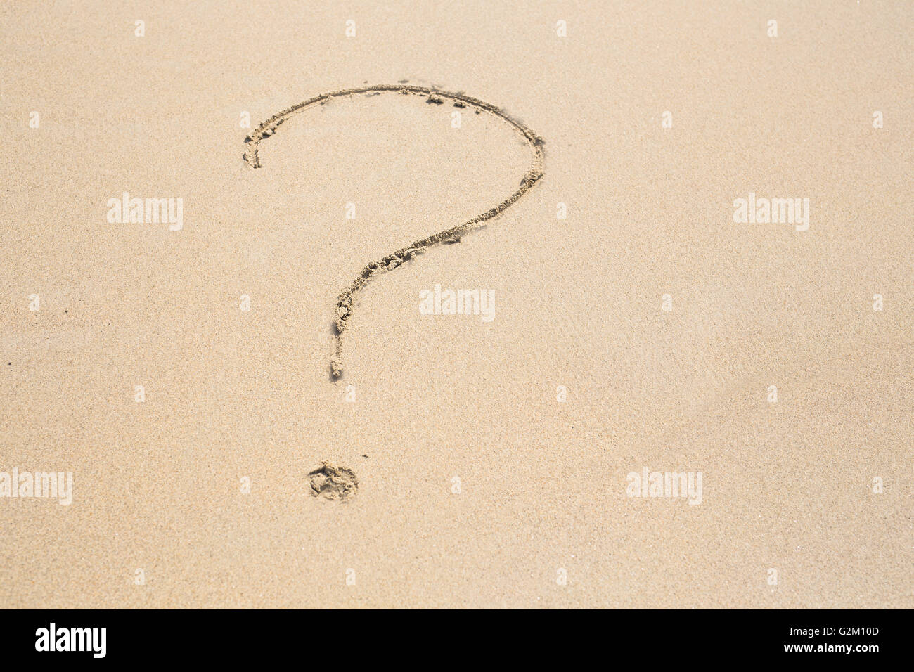 question mark drawn on the sand of a beach Stock Photo - Alamy