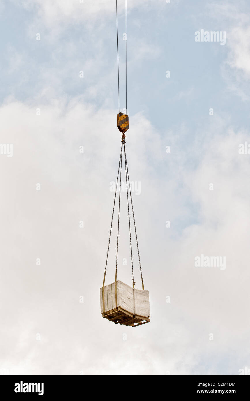 heavy load of bricks hanging on the crane's hook Stock Photo - Alamy