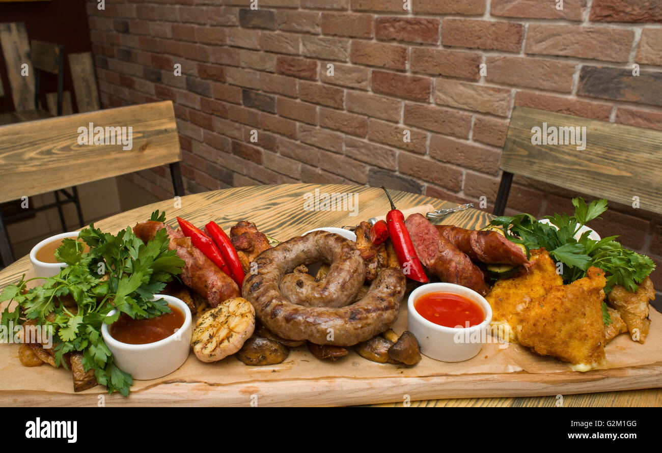 Meat desk with sauces and vegetables Stock Photo - Alamy