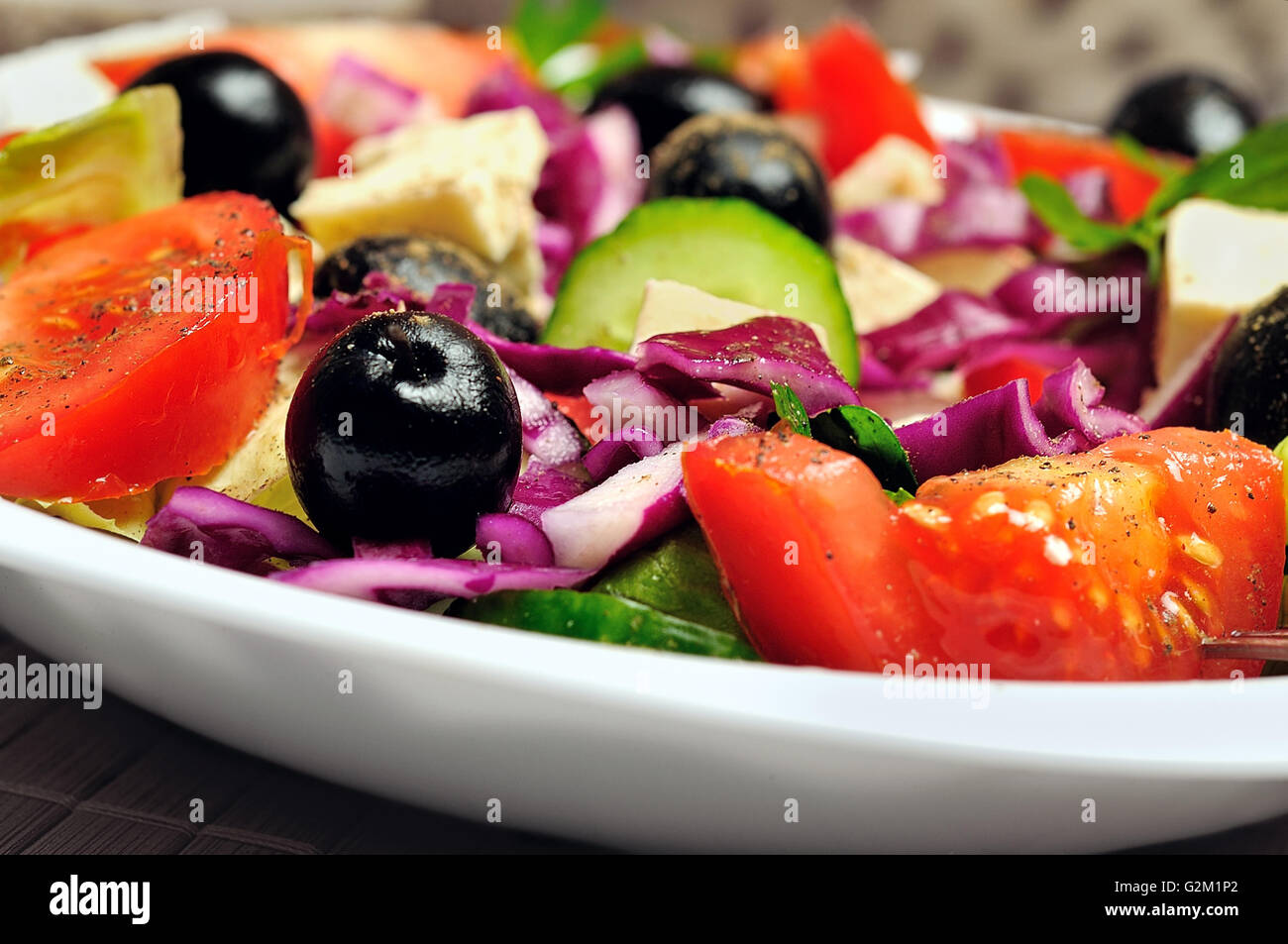 Plate with salad on table Stock Photo - Alamy