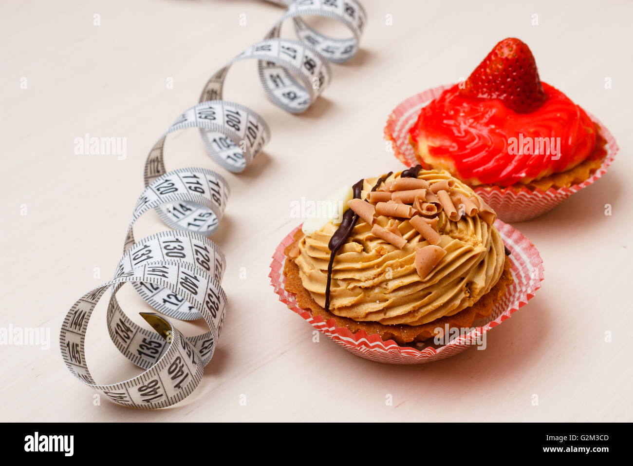Appetite and gluttony concept. Fattening problem. Cakes cupcakes with ...