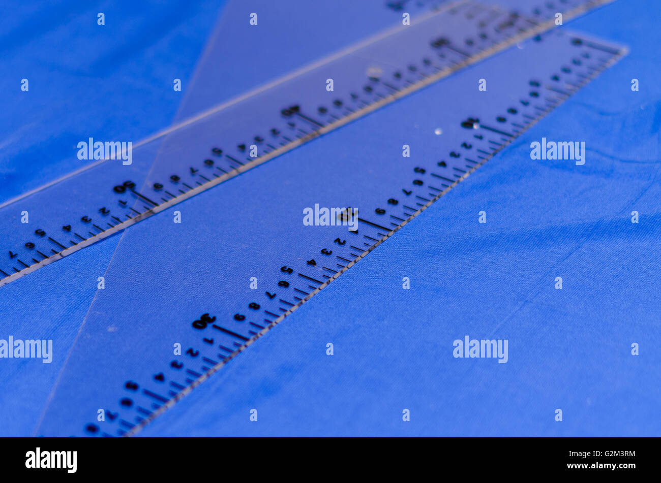 Plastic rulers with blue background, isolated with measurements in ...