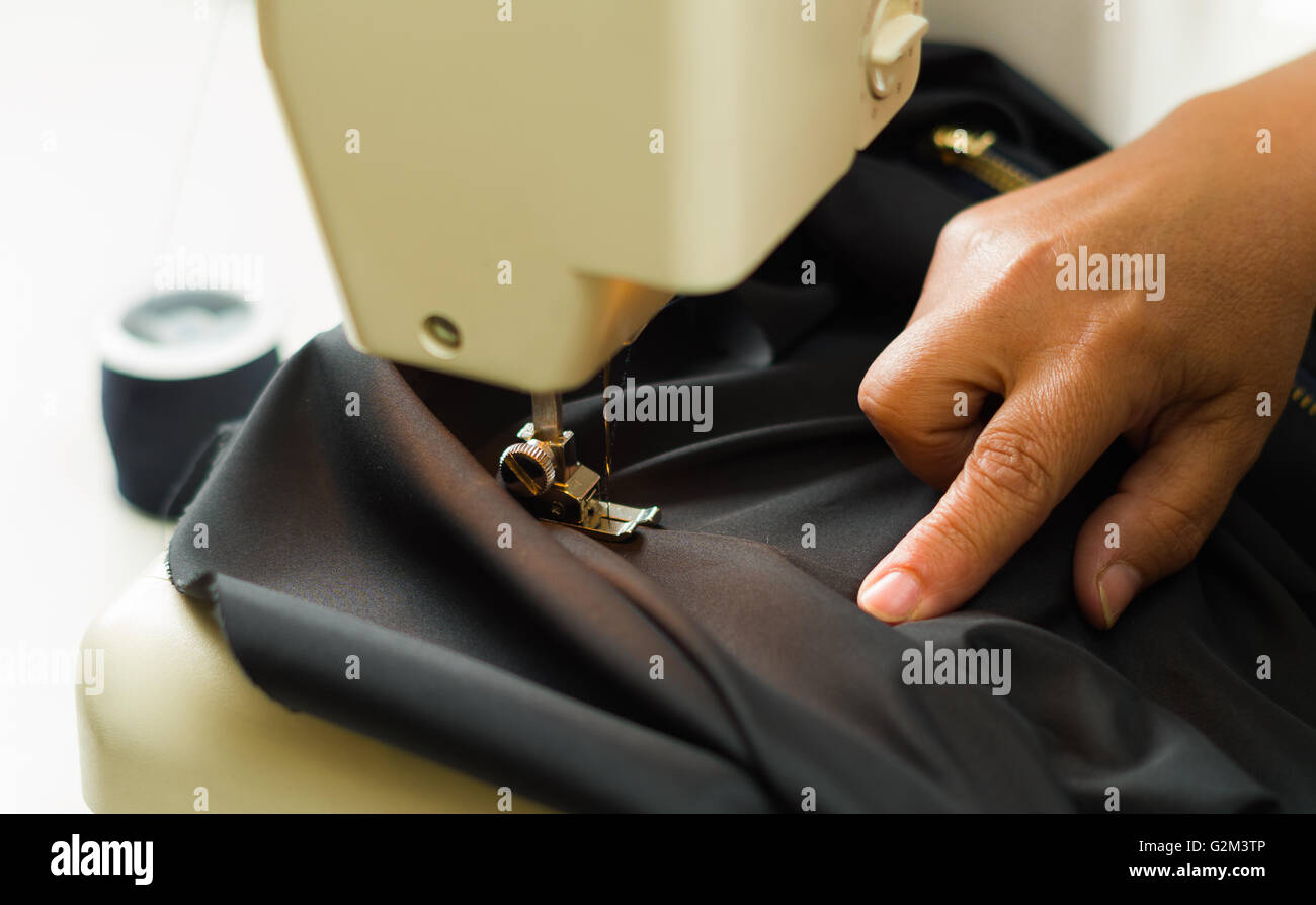 Dress making process, seamstress working on a sewing machine, close up ...