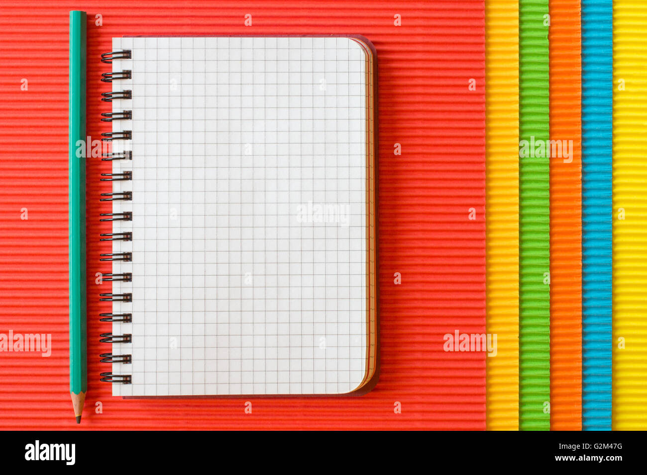 Blank notebook with pencil on colored corrugated paper Stock Photo - Alamy