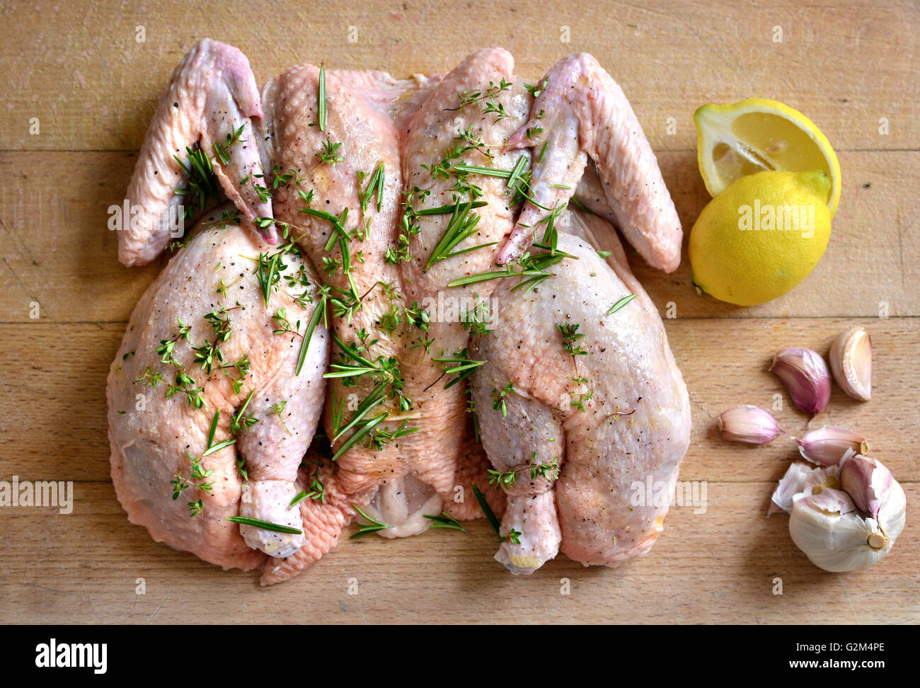 Raw spatchcock (butterfly) chicken and herbs Stock Photo - Alamy