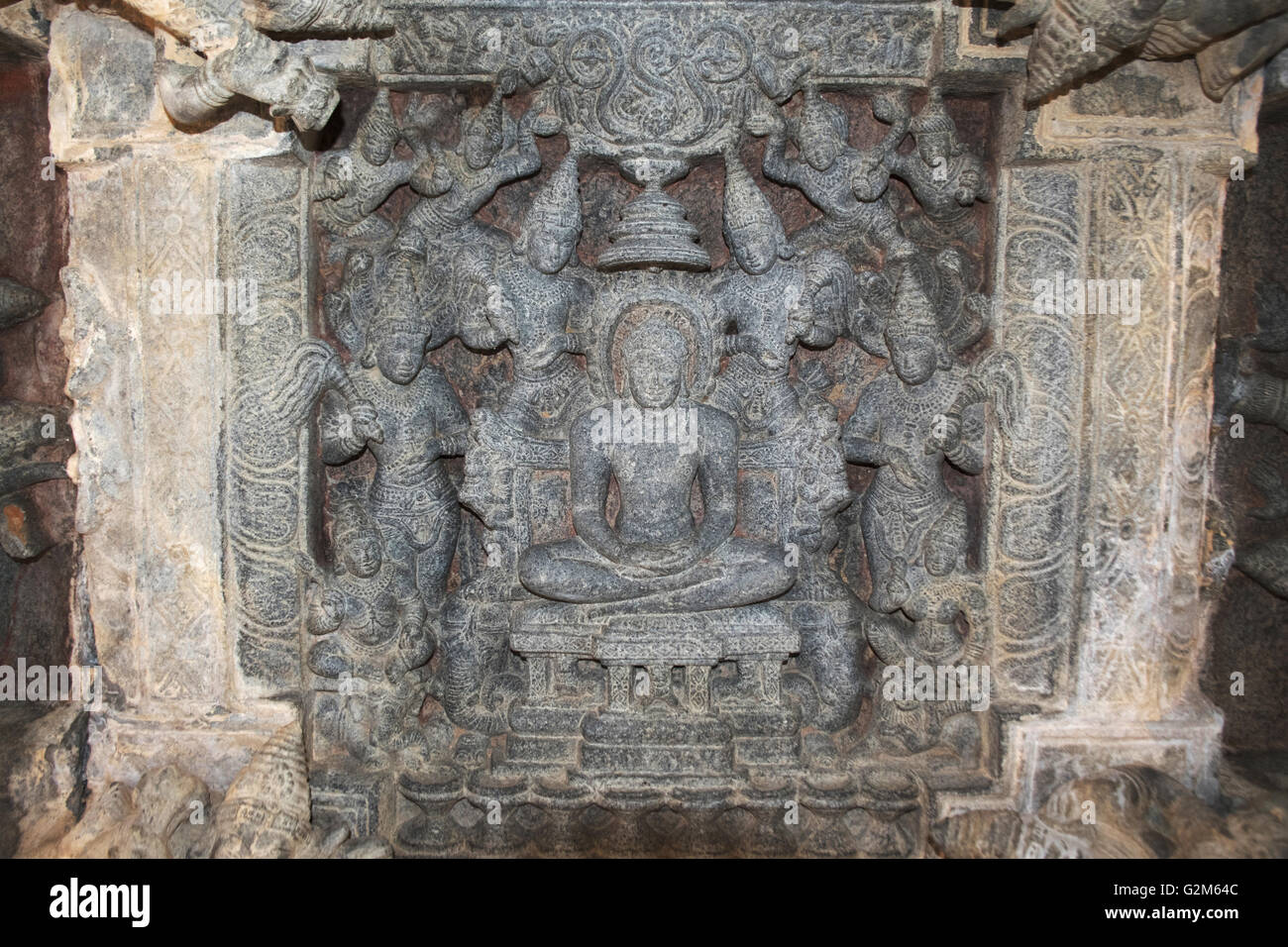 Carved figure of Jain tirthankara with his consorts at the ceiling of ...