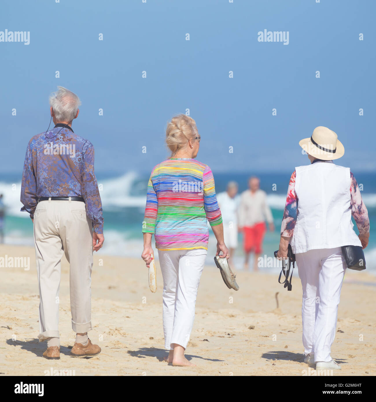 Active seniors enjoying beach walk Stock Photo - Alamy