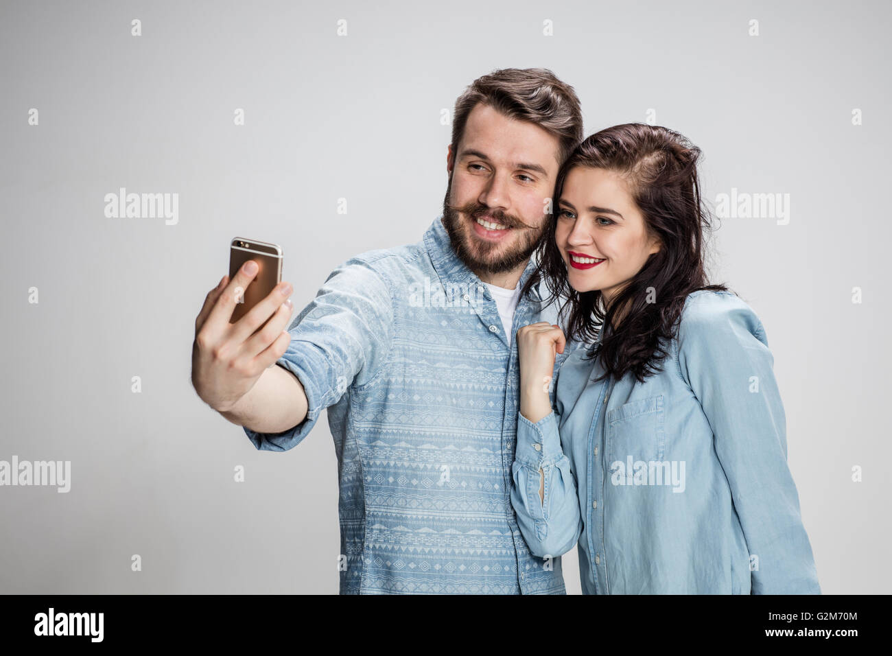 Portrait of happy couple on gray background Stock Photo - Alamy