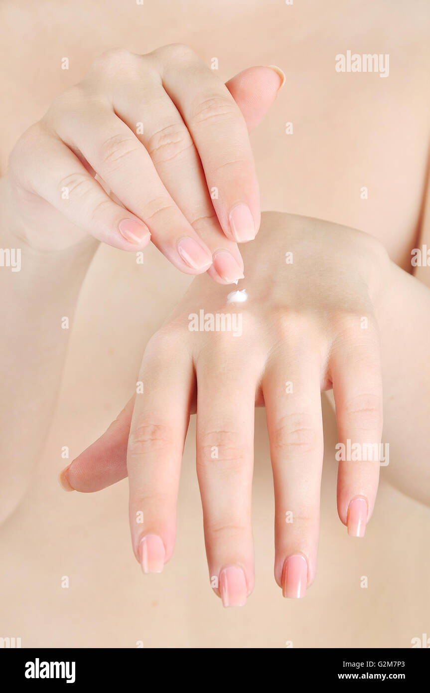 Woman applying cream on hand Stock Photo - Alamy