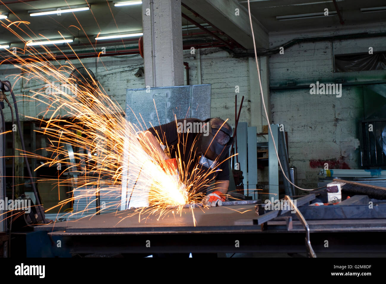 sparks during working with steel in the factory Stock Photo - Alamy