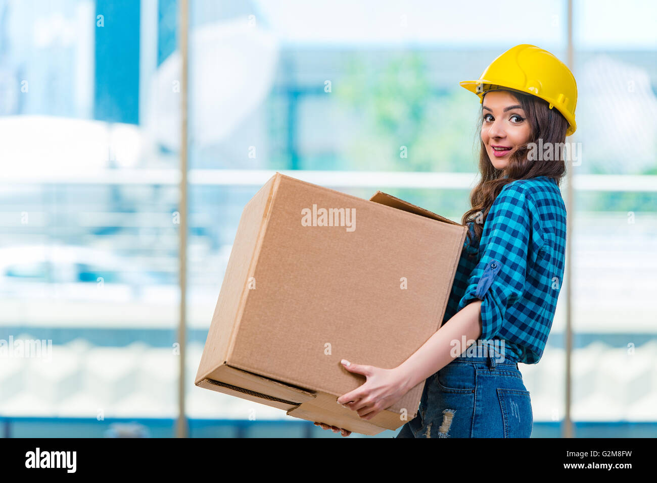 Nice young woman carrying box Stock Photo - Alamy