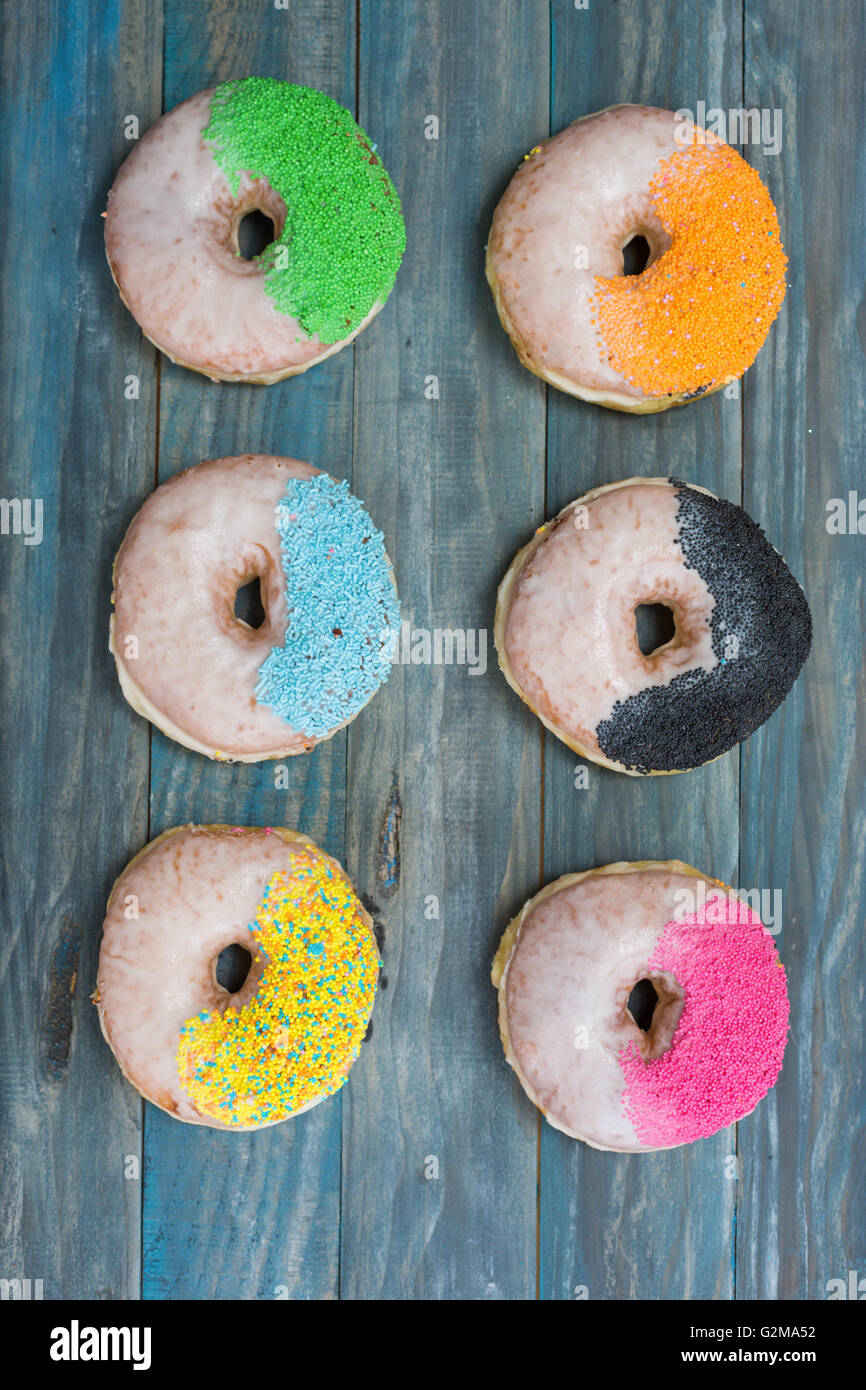 Hand decorated artisan donuts on wooden rustic table, from above Stock ...