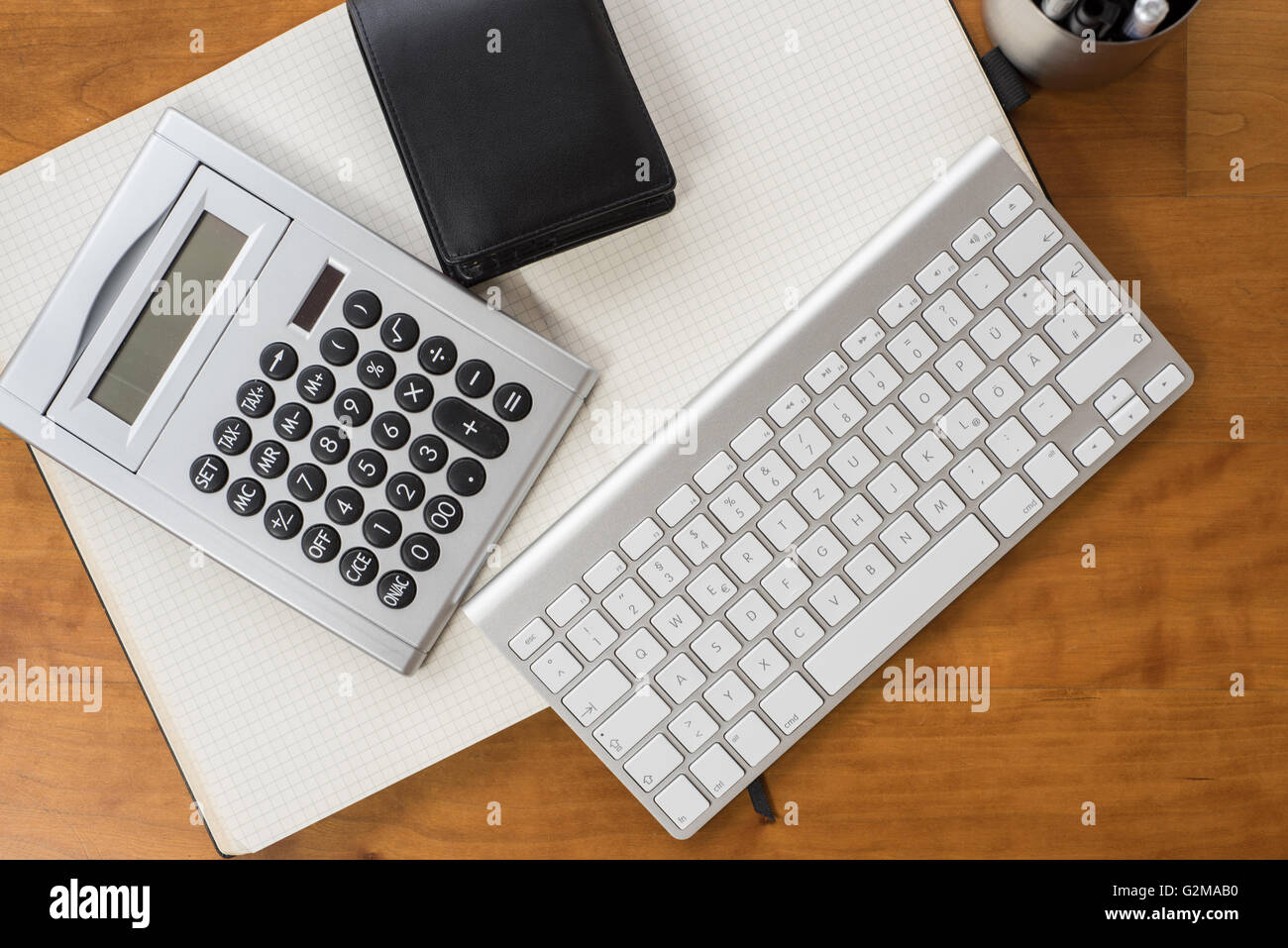 wooden desk with keyboard, smartphone, calculator and notebook Stock ...