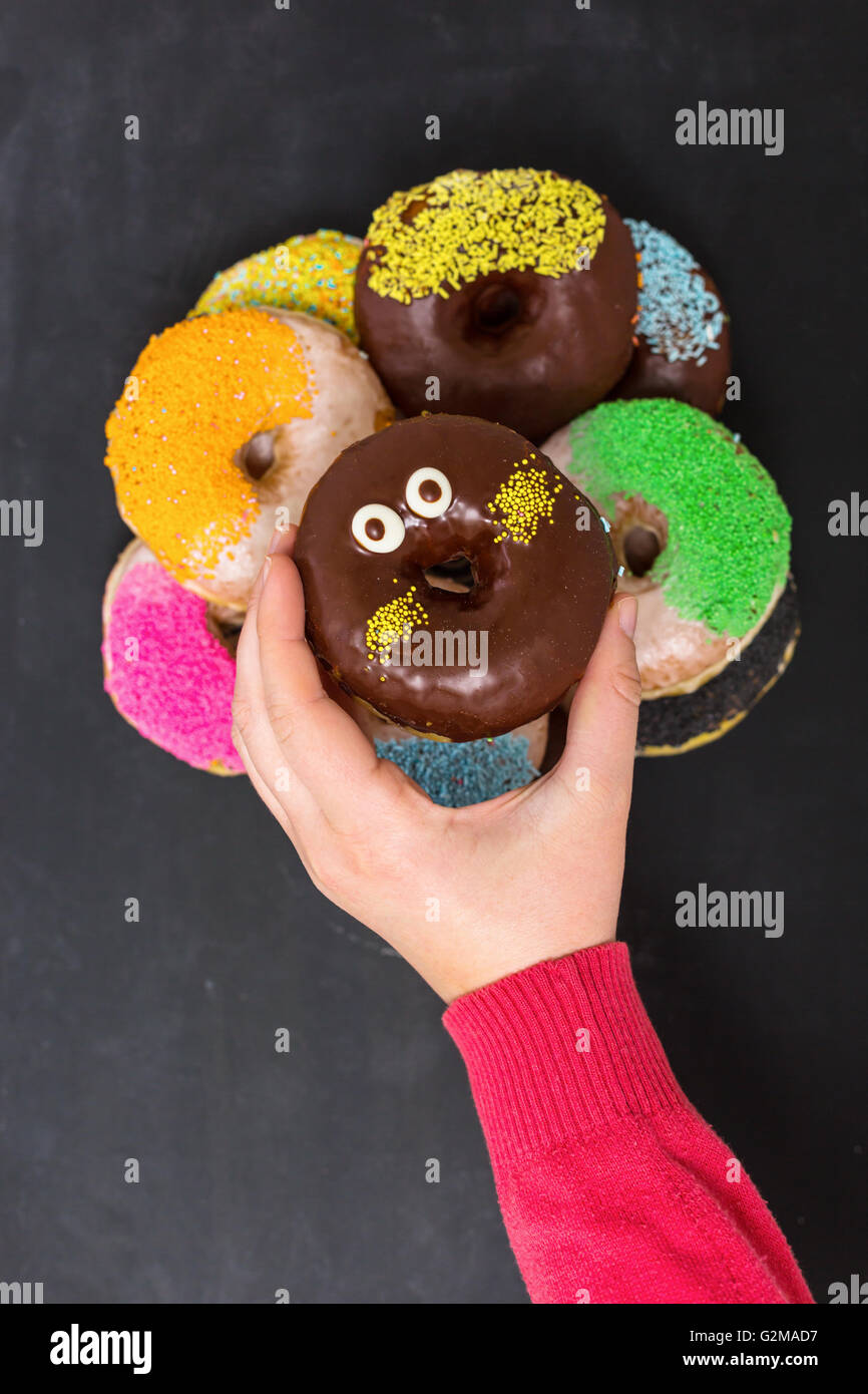 Hand grabbing donut hi-res stock photography and images - Alamy