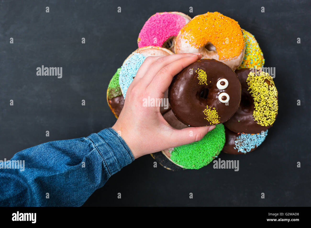 female hand reaching to grab the doughnut Stock Photo - Alamy