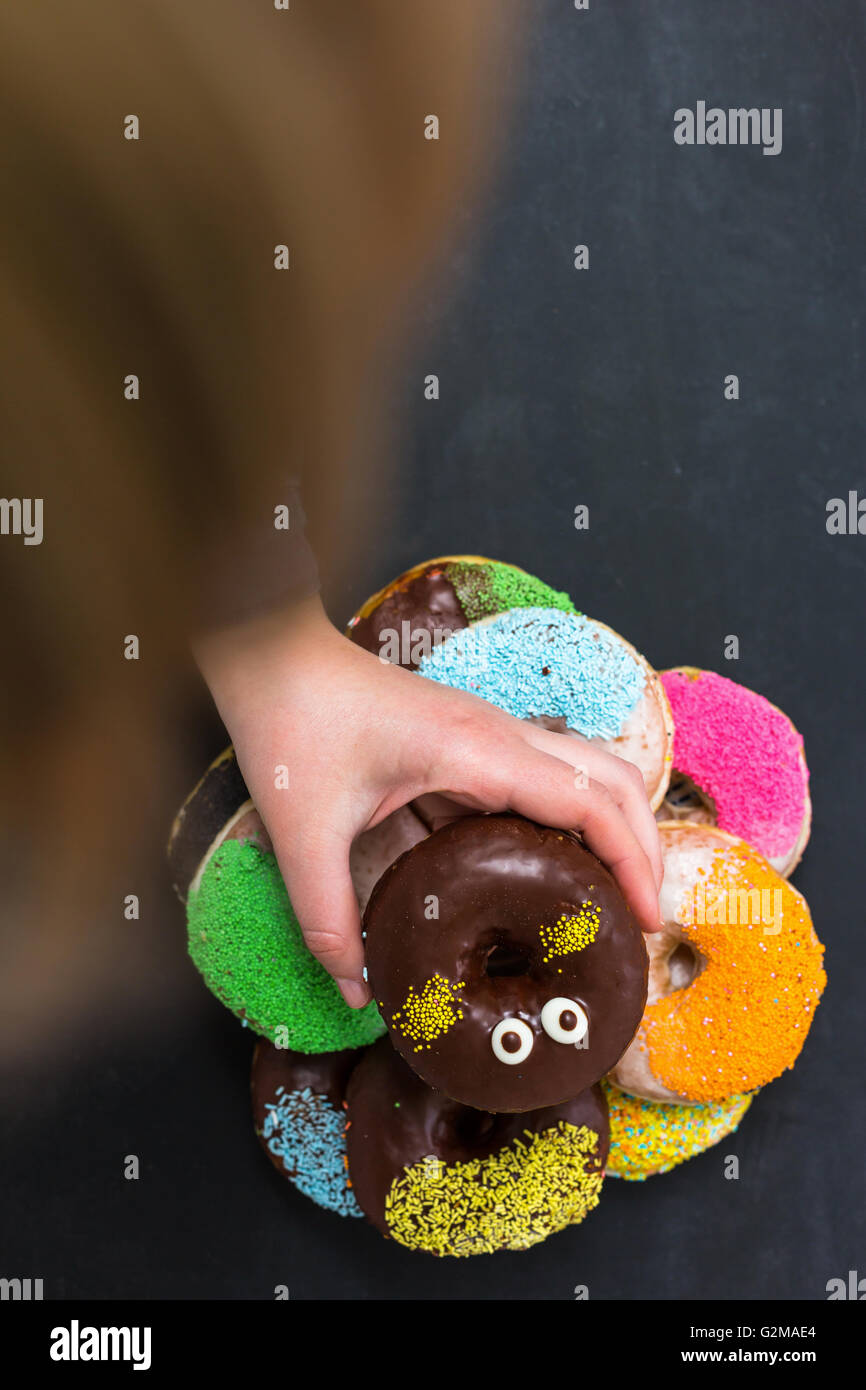 female hand reaching to grab the doughnut Stock Photo - Alamy