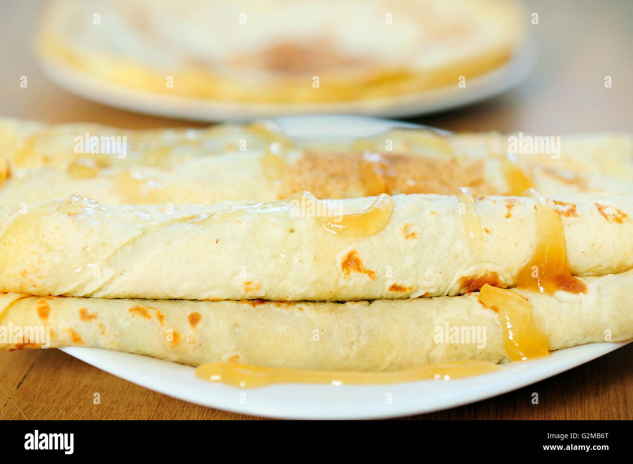 Plate with pancake on table Stock Photo - Alamy