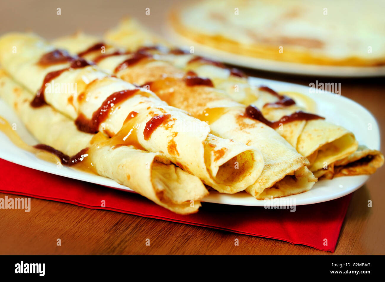 Plate with pancake on table Stock Photo - Alamy