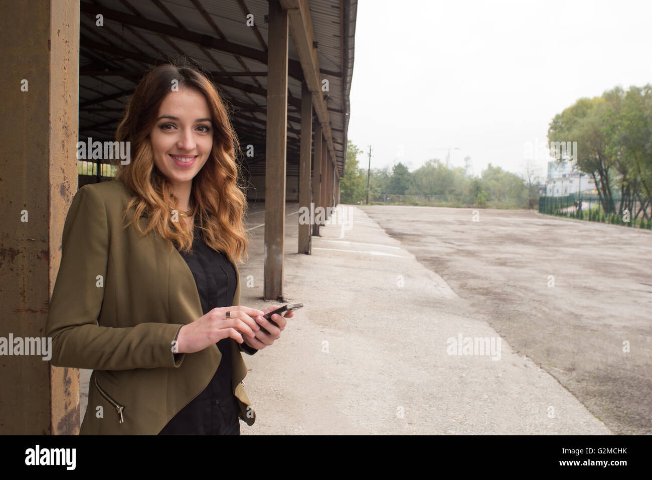 Female site manager using phone to communicate Stock Photo - Alamy