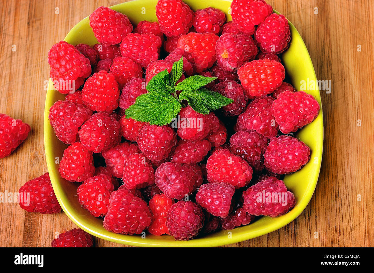 Bowl with raspberry on table Stock Photo - Alamy