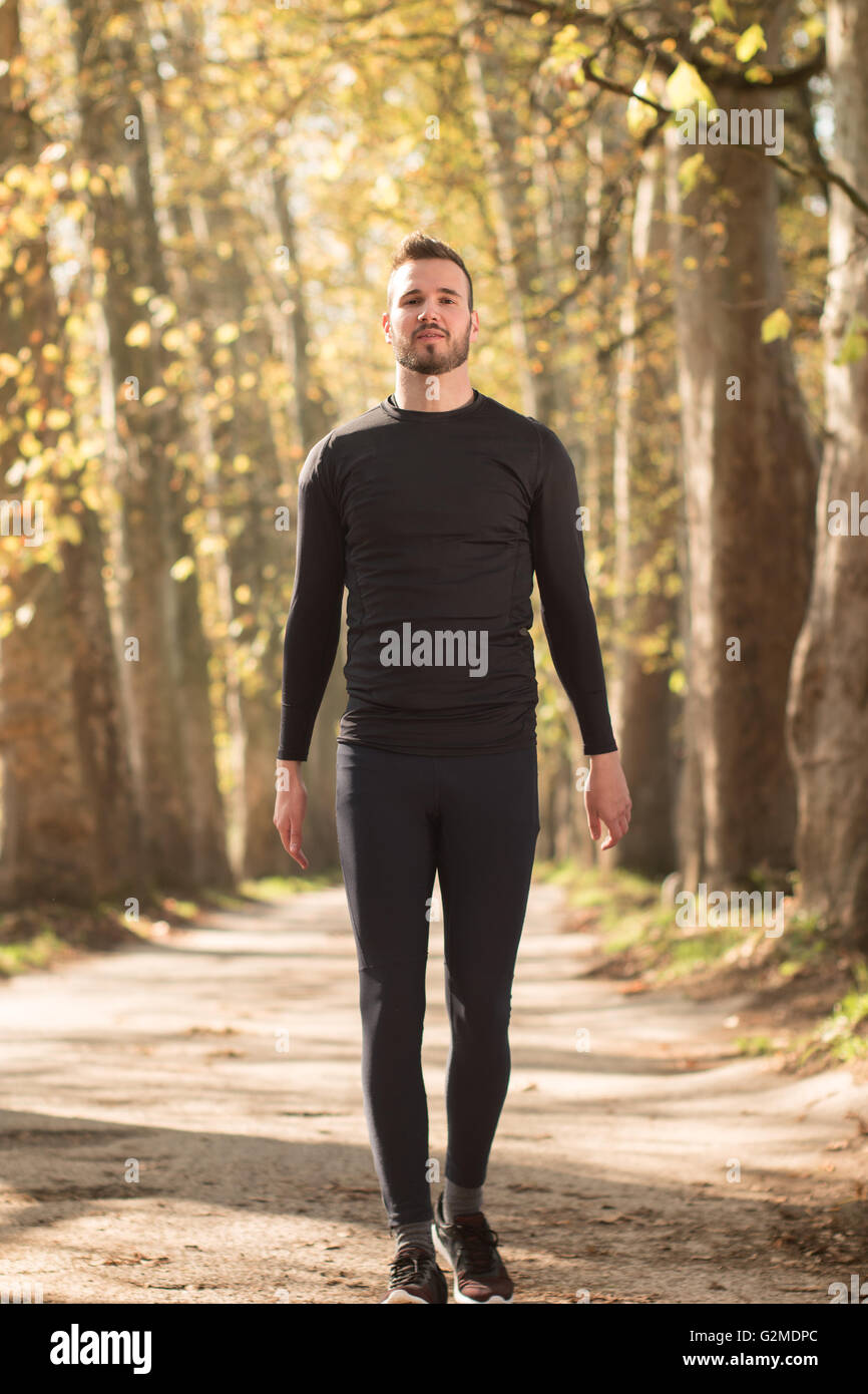 Runner resting tired and exhausted after running. Jogging man taking a ...