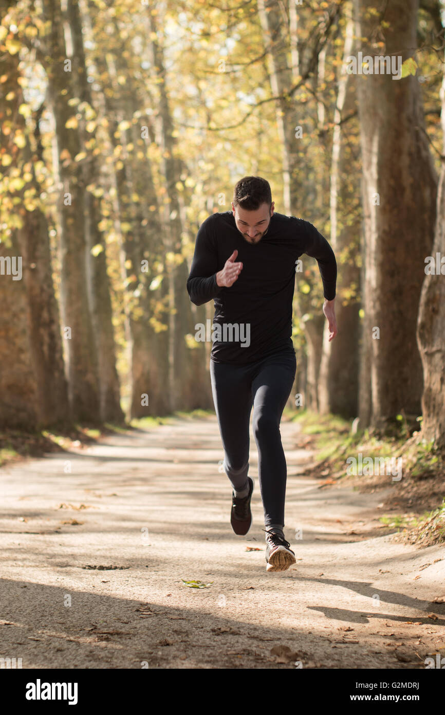 Runner man running on road training sprint for marathon run. Sporty fit ...