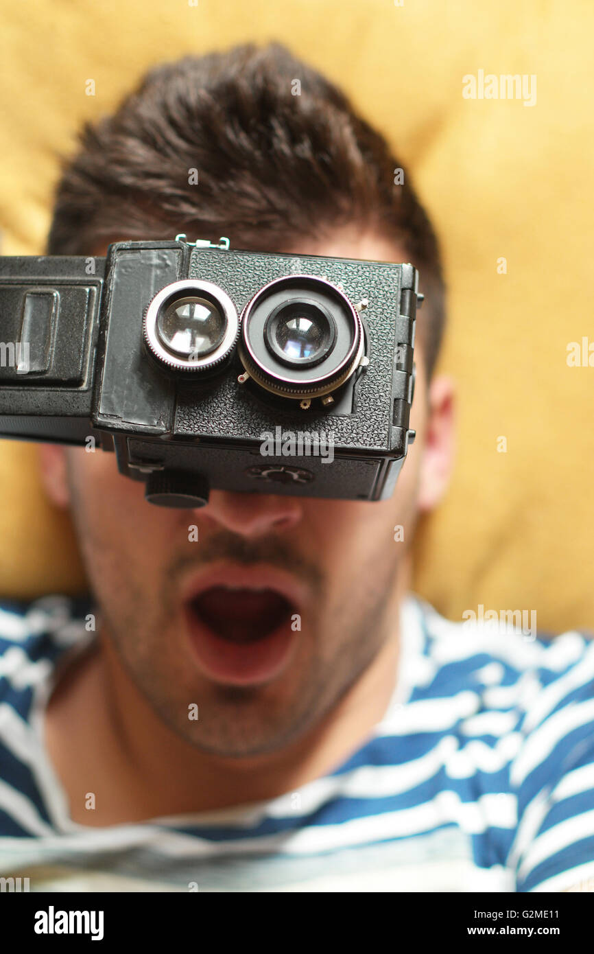 Young man using a vintage camera Stock Photo - Alamy