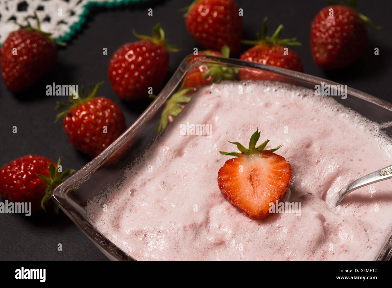 Strawberry smooothie with straberries in the background. High ...