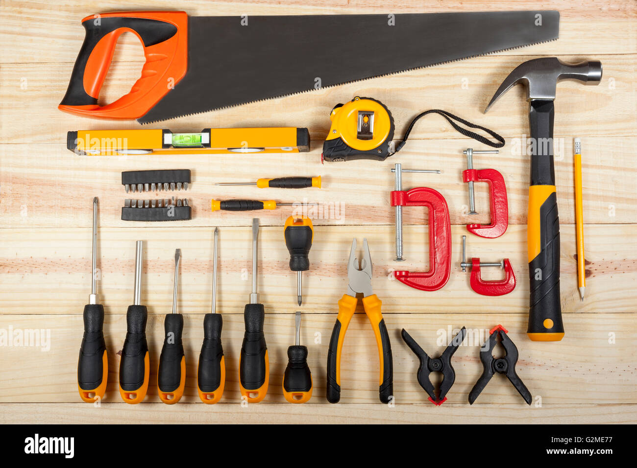 Workman;s toolkit in a flat lay display on a boarded wooden background ...