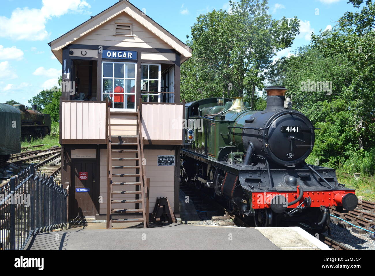 Ex-GWR 5101 Class locomotive No.4141 draws into Ongar Station past the ...