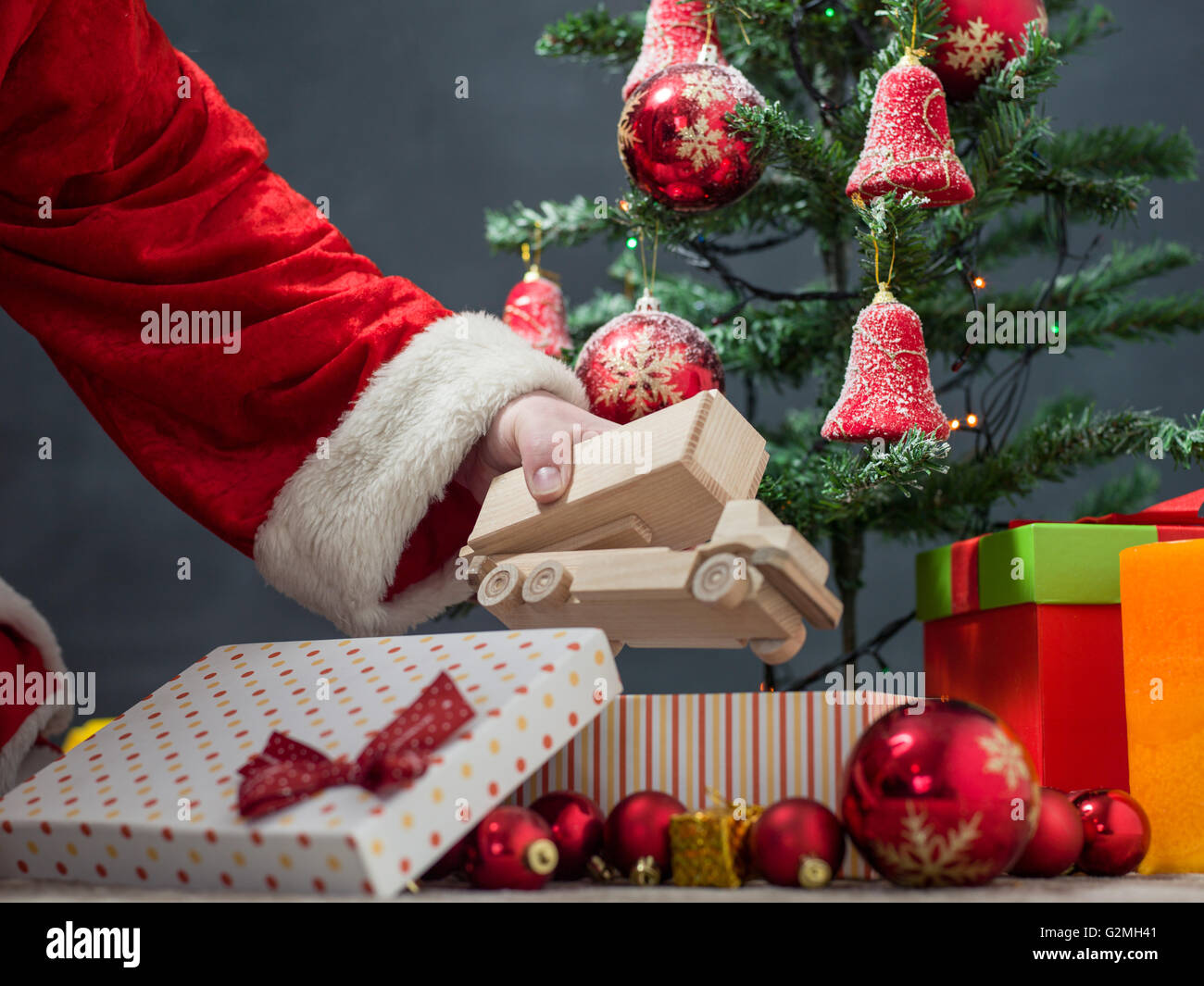 Putting gifts under fir tree hi-res stock photography and images - Alamy
