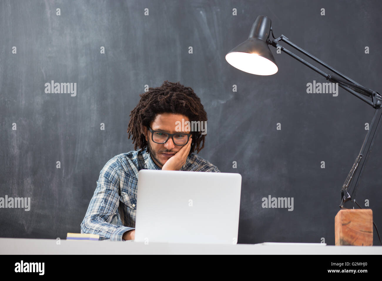 Portrait of smart businessman busy working at desk, using mobile phone ...