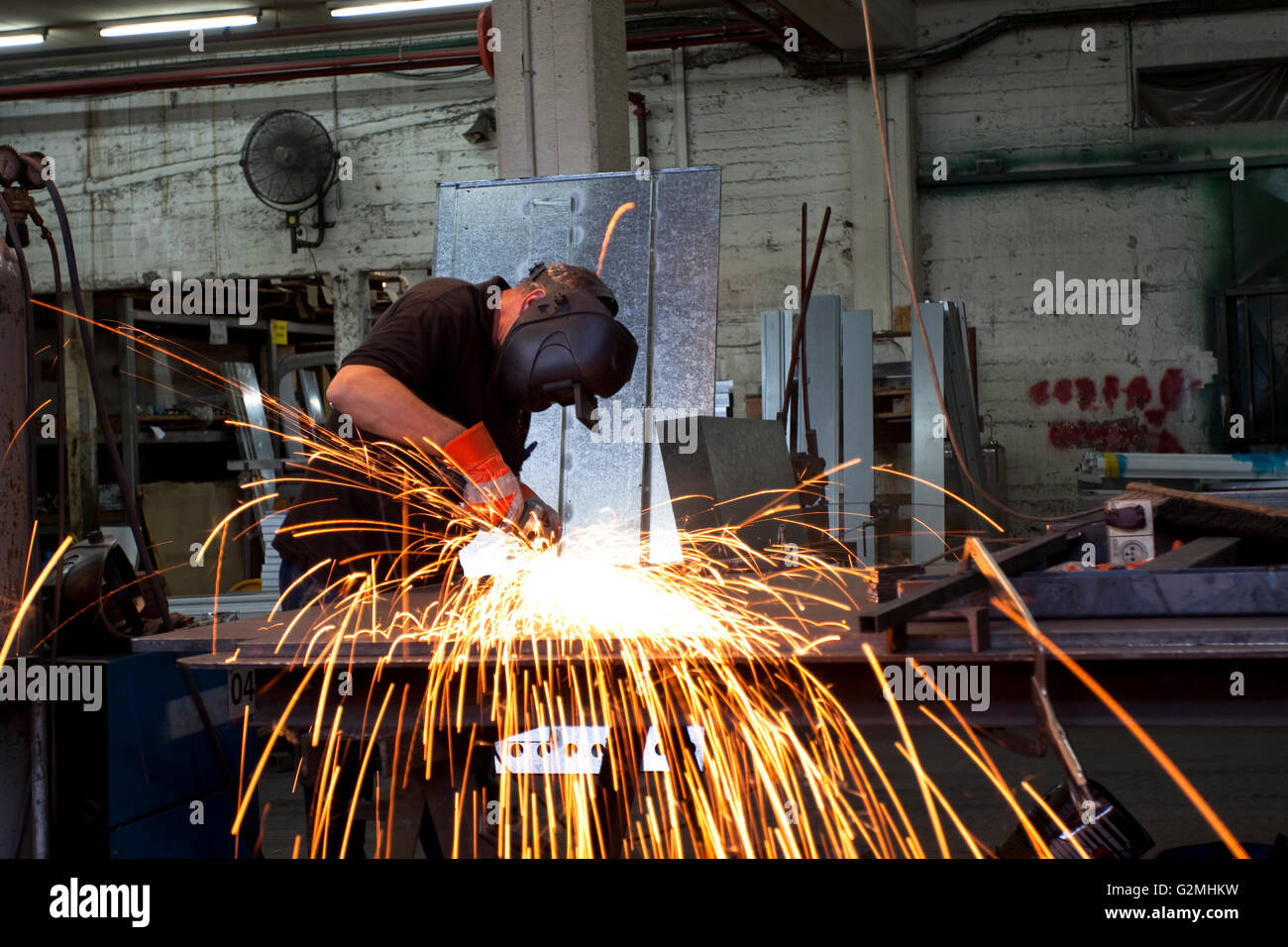 sparks during working with steel in the factory Stock Photo - Alamy
