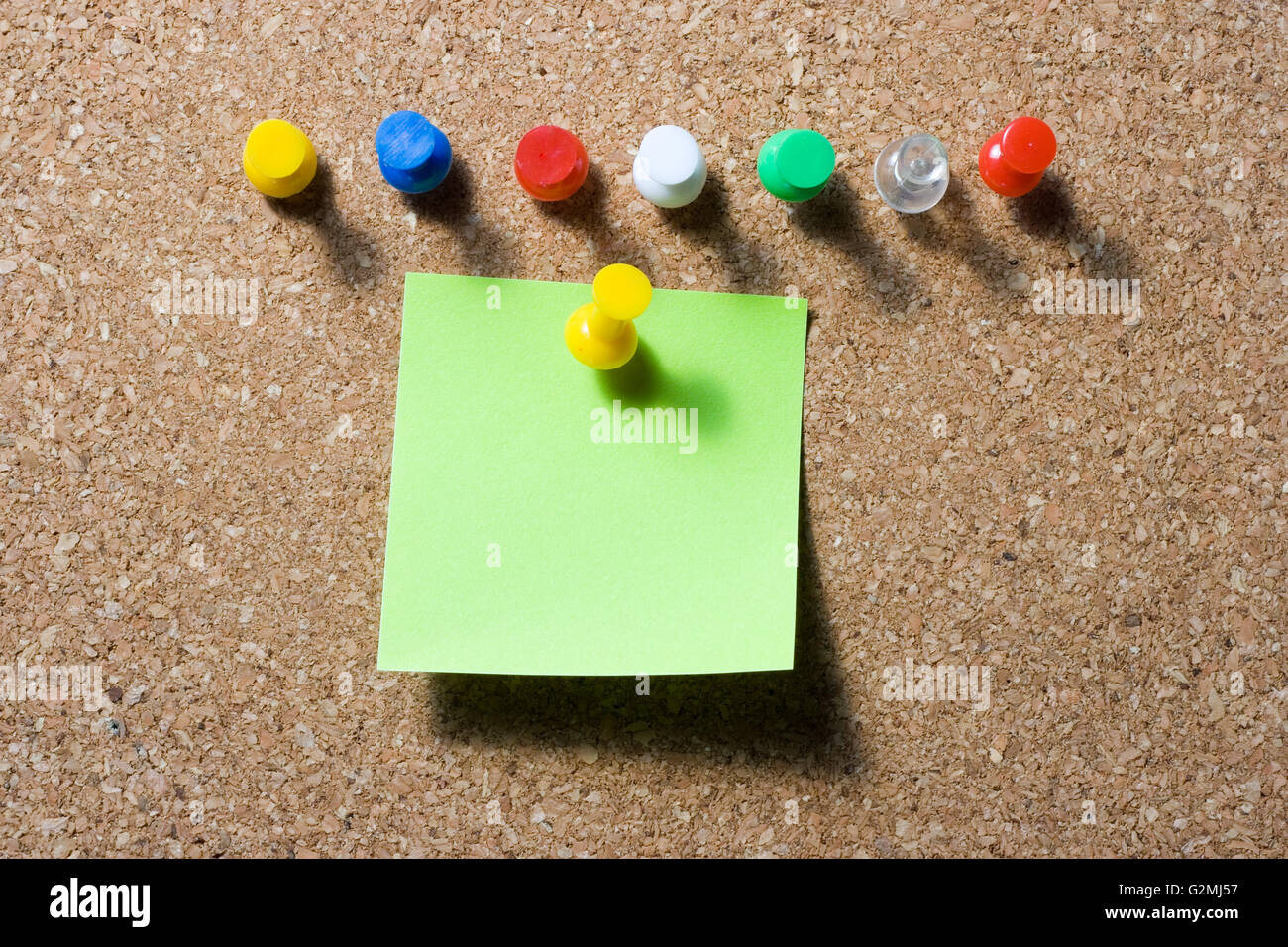 green reminder with yellow push pin Stock Photo - Alamy