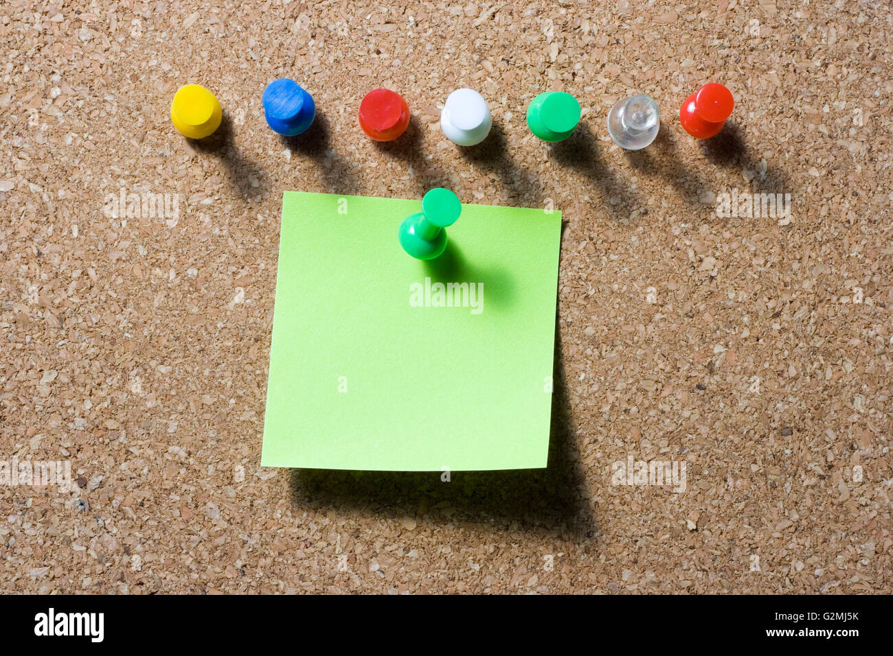 green reminder with green push pin Stock Photo - Alamy