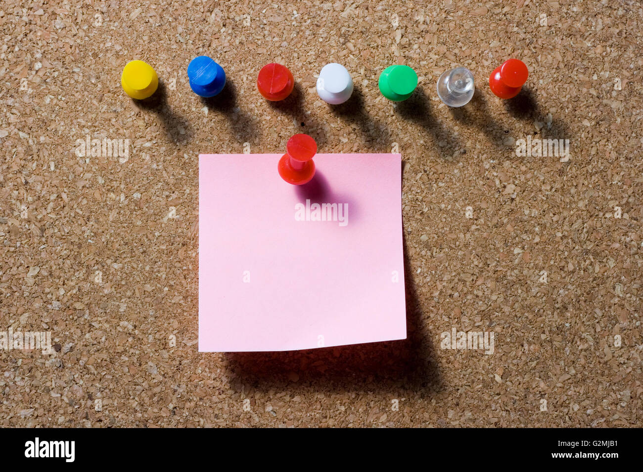 pink reminder with red push pin Stock Photo - Alamy