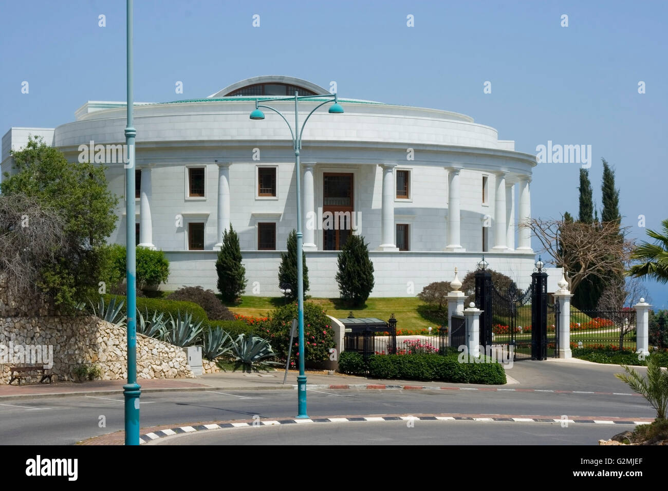 round white building with black gate and blue sky Stock Photo - Alamy