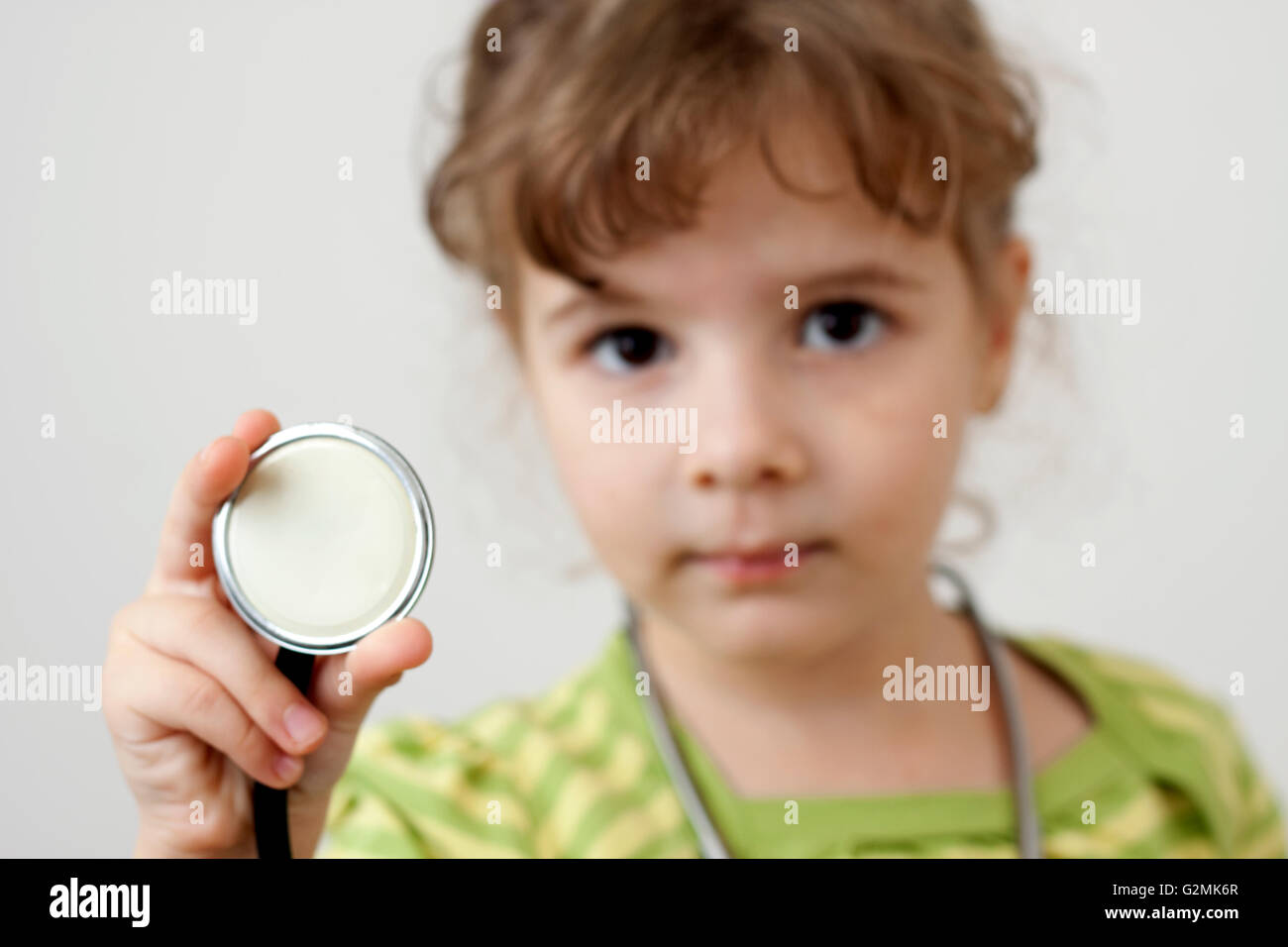 little girl playing nurse with stethoscope selsctive focus Stock Photo ...