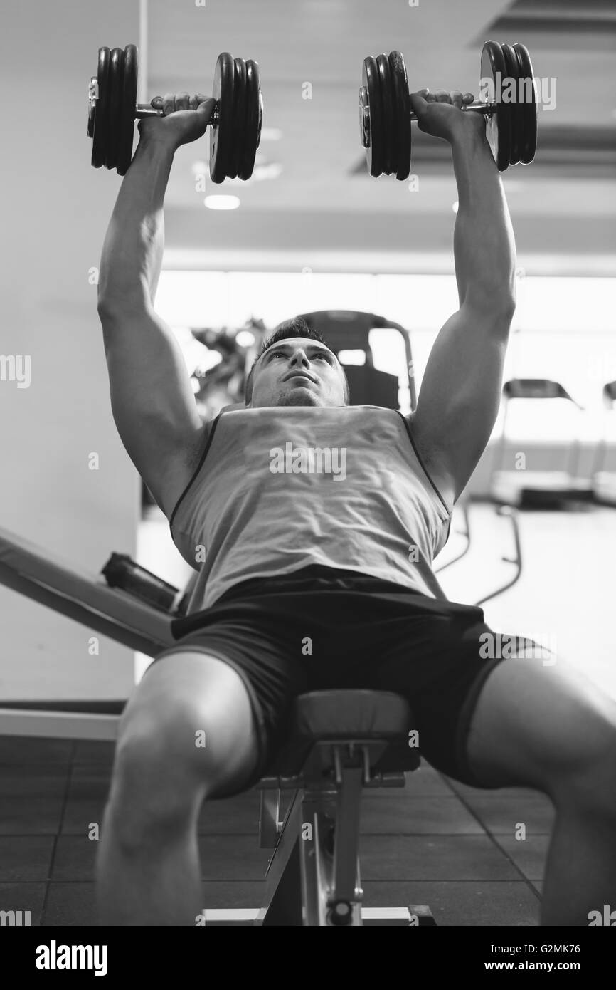 Muscular Young Man Doing Heavy Weight Exercise For Biceps With ...