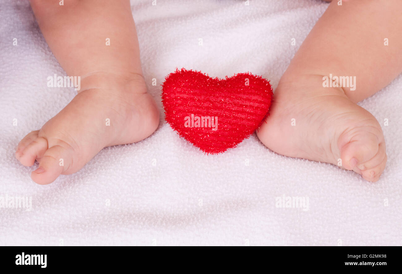 small baby feet with red heart between on white background Stock Photo ...