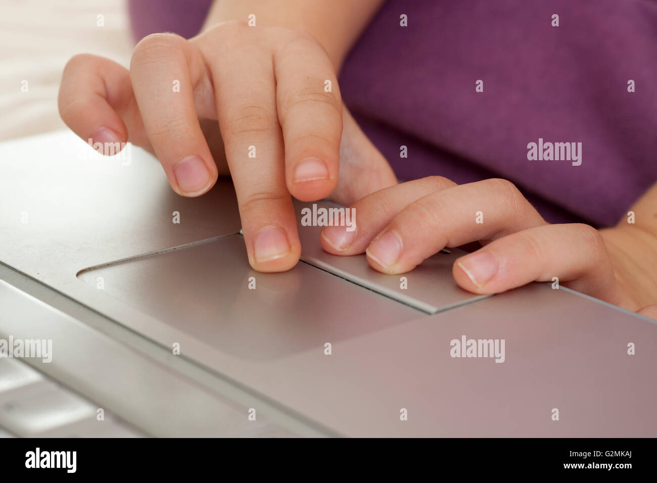 little girl fingers on a silver laptop's trackpad Stock Photo - Alamy